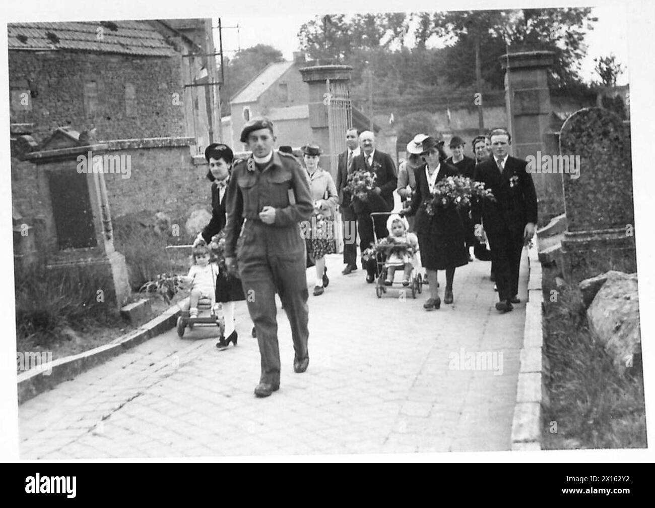 BASTILLE DAY IN NORMANDY - Villagers arriving for the service. A Padre ...