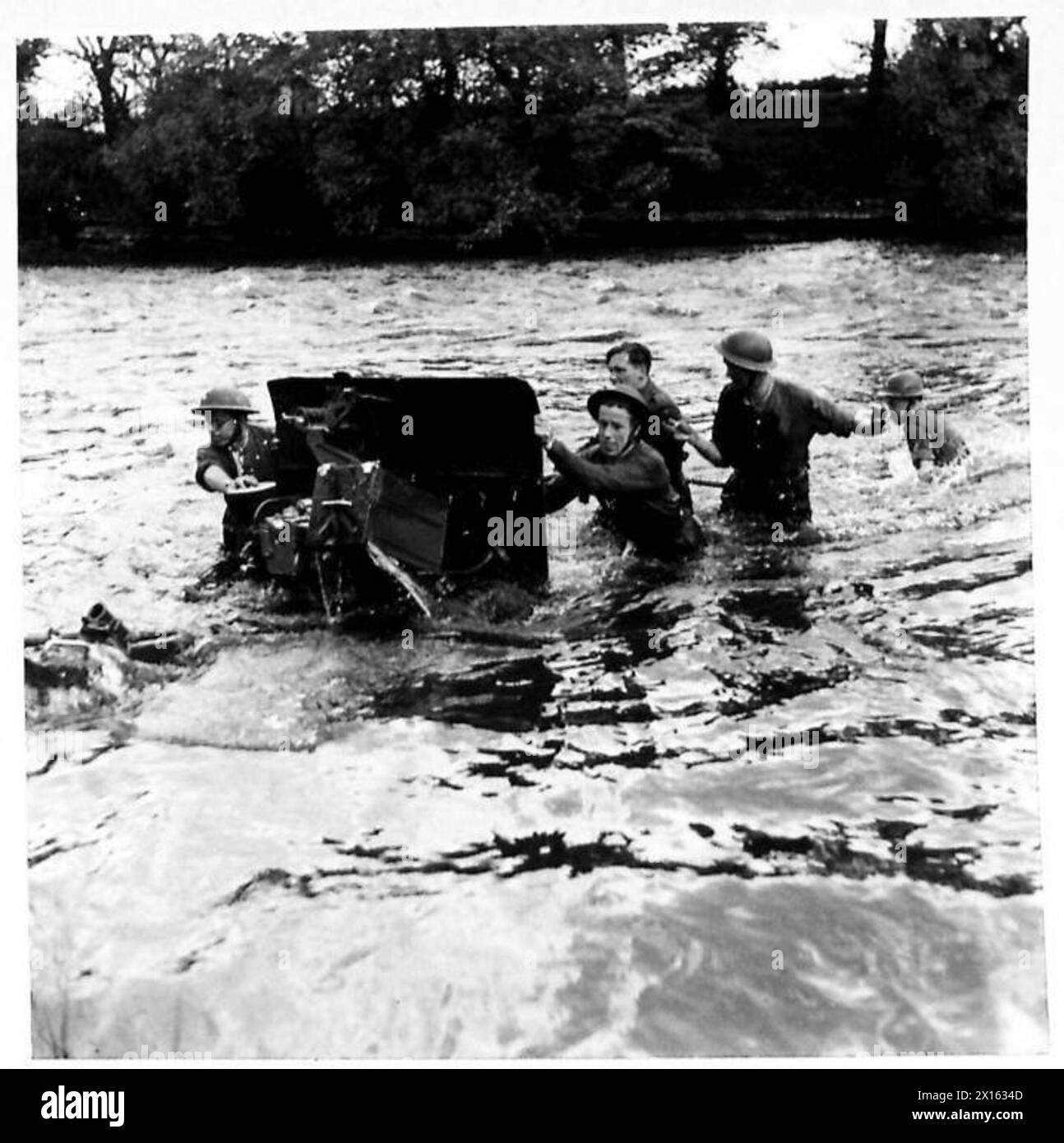 GETTING THE GUNS ACROSS - The anti-tank gun being manhandled as it ...