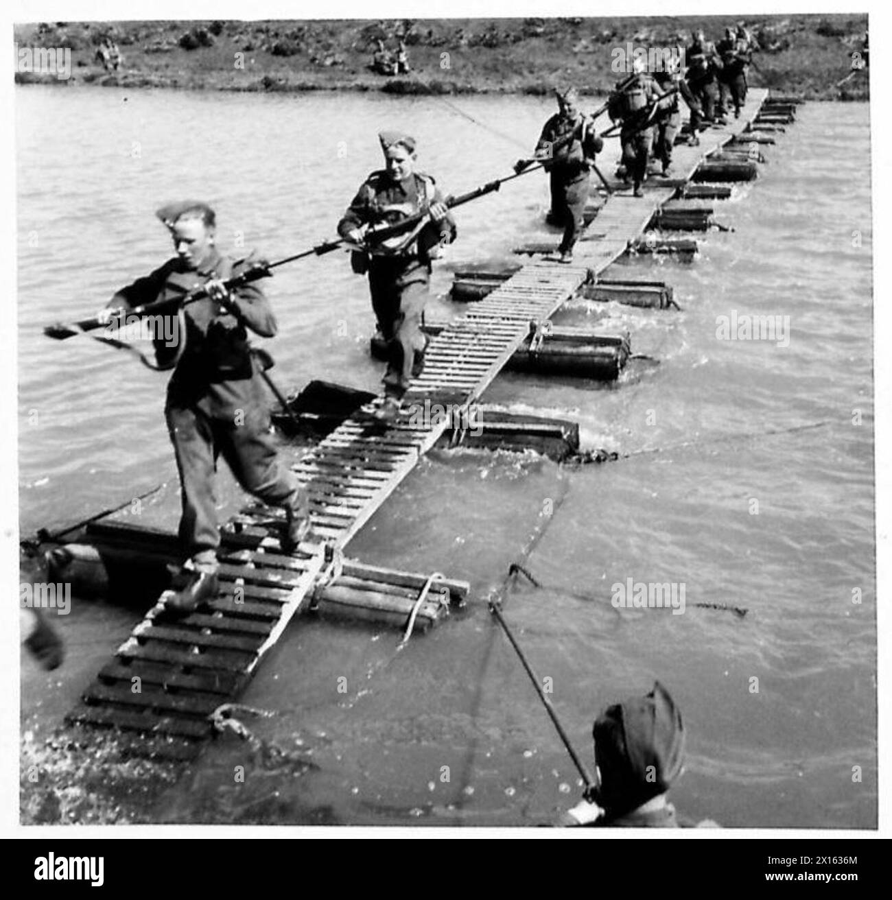 INFANTRYMEN LEARN THE ART OF BRIDGING - The bridge spans the river and ...
