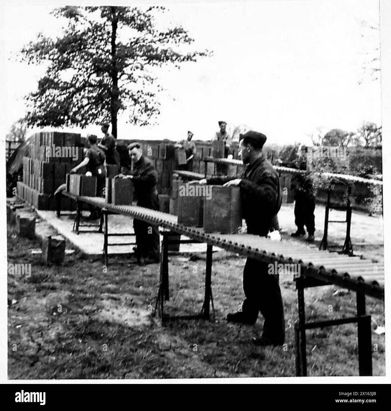Personnel load and unload petrol cans using a roller system at a ...