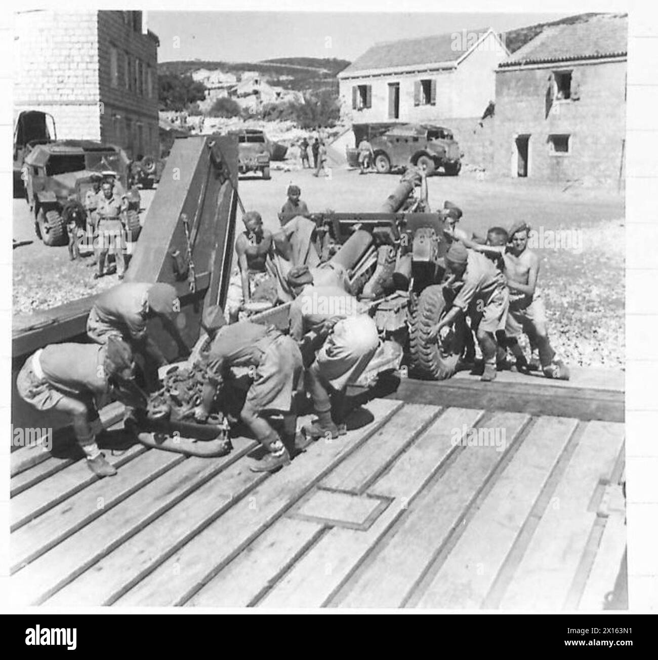 Gunners at VIS load RCLs with ammunition and 25-pounder shells during ...