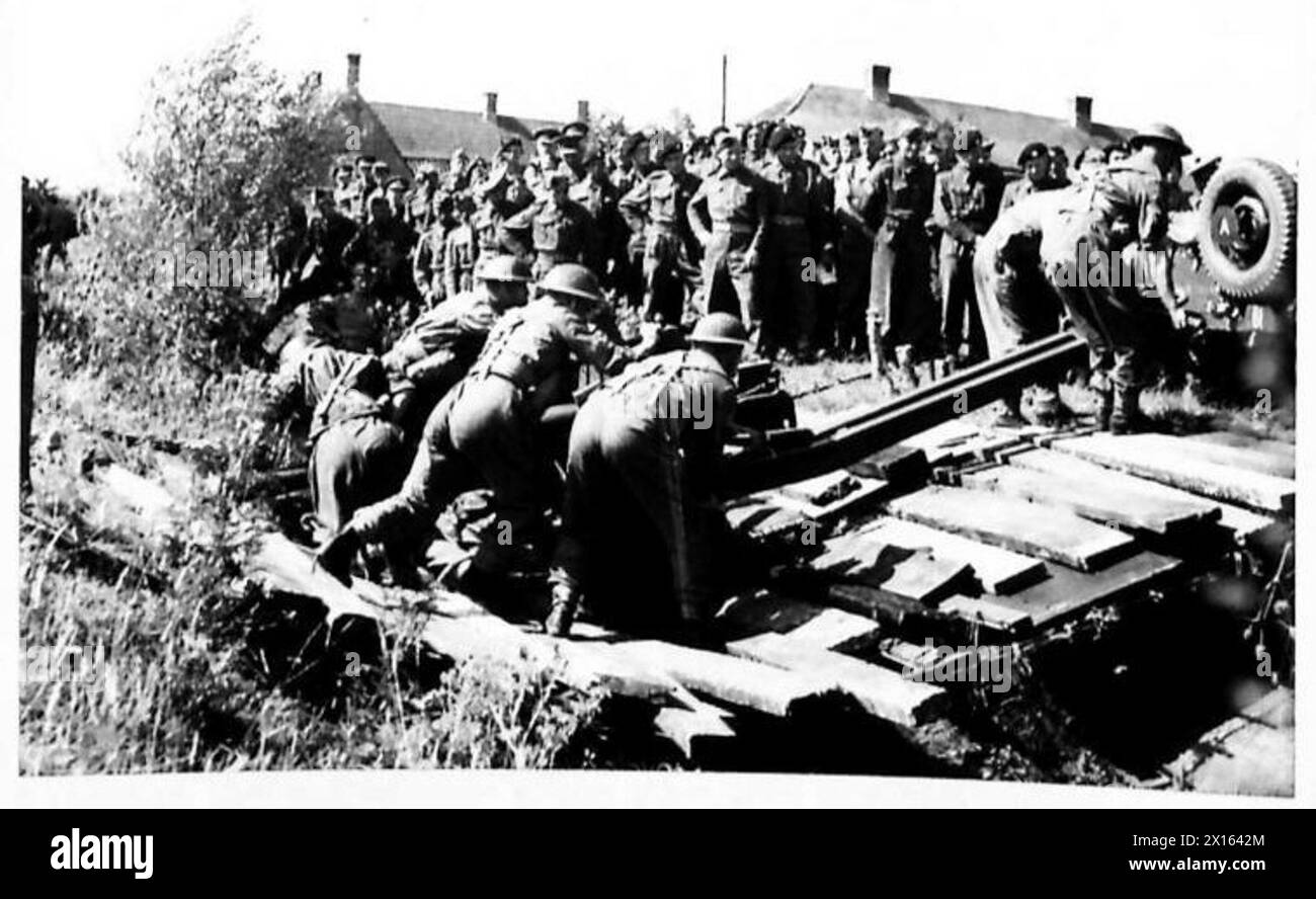 A 6-pounder anti-tank gun crosses a bridge as part of a river crossing ...