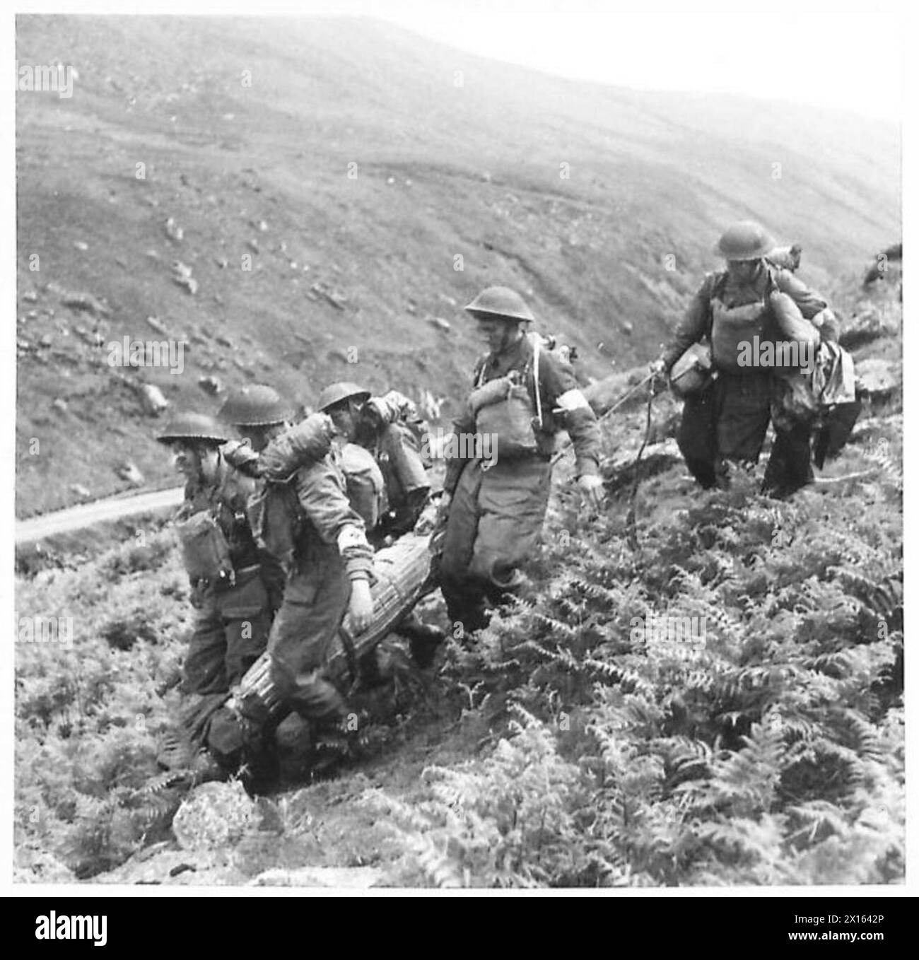 ROYAL ARMY MEDICAL CORPS EXERCISE - The "casualty" is brought down a ...