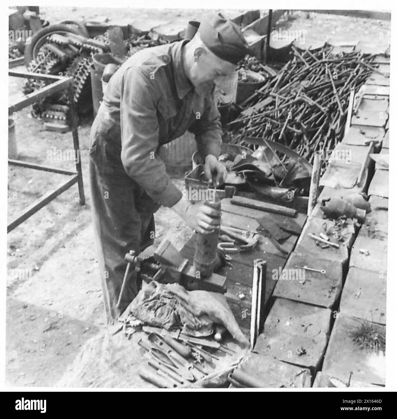 ARMY SALVAGE - A scene at the stripping bench. Here the brass nose cap ...