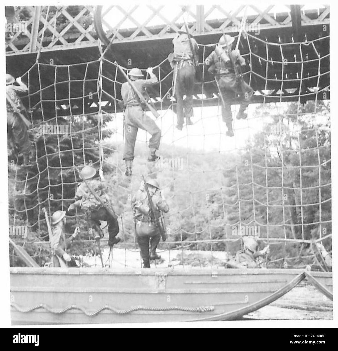 SCOTTISH HOME GUARDS' COMMANDO TRAINING - Climbing a rope net on to a ...