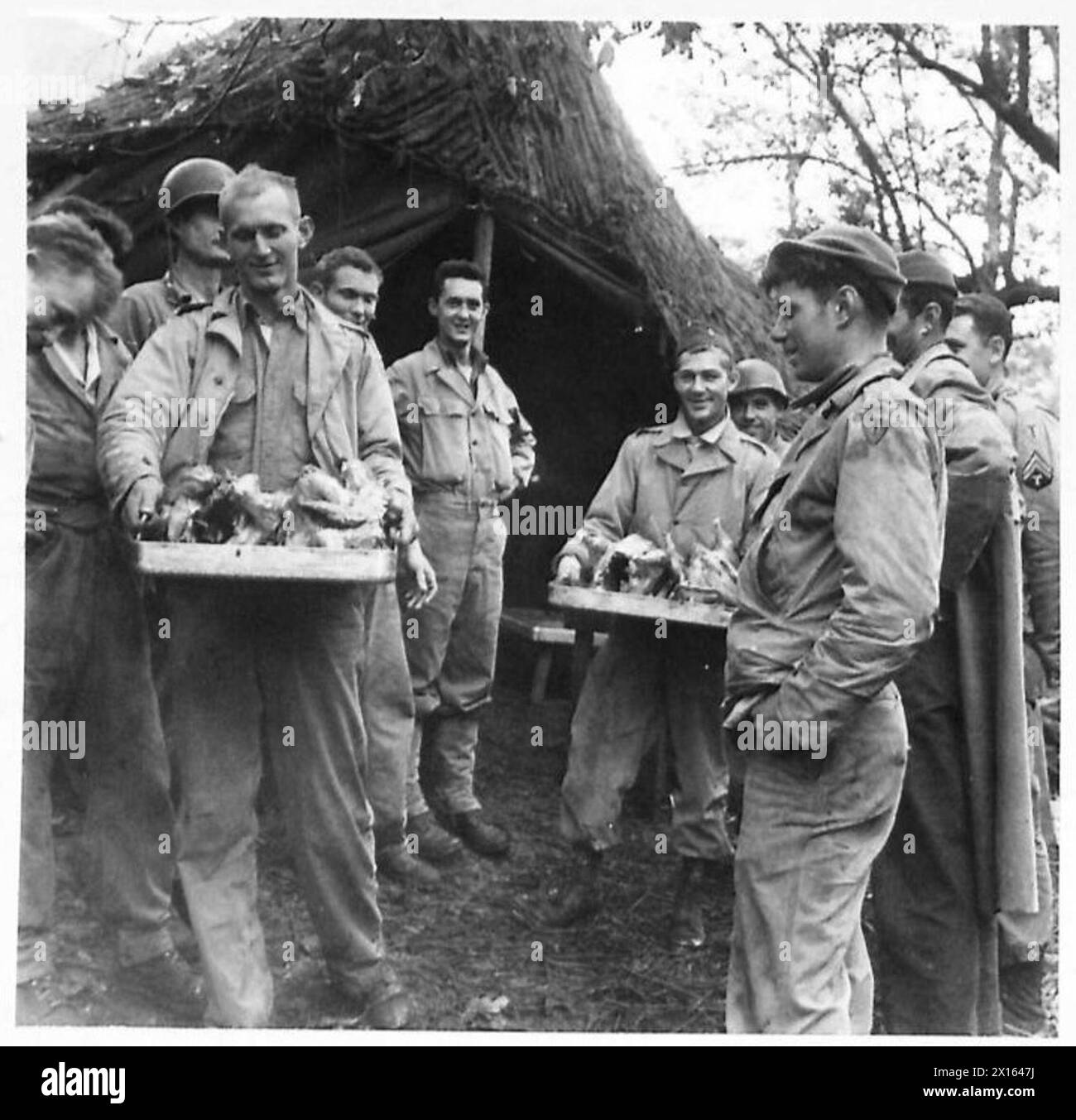Two American army cooks prepare roast turkey in the Fifth Army's ...