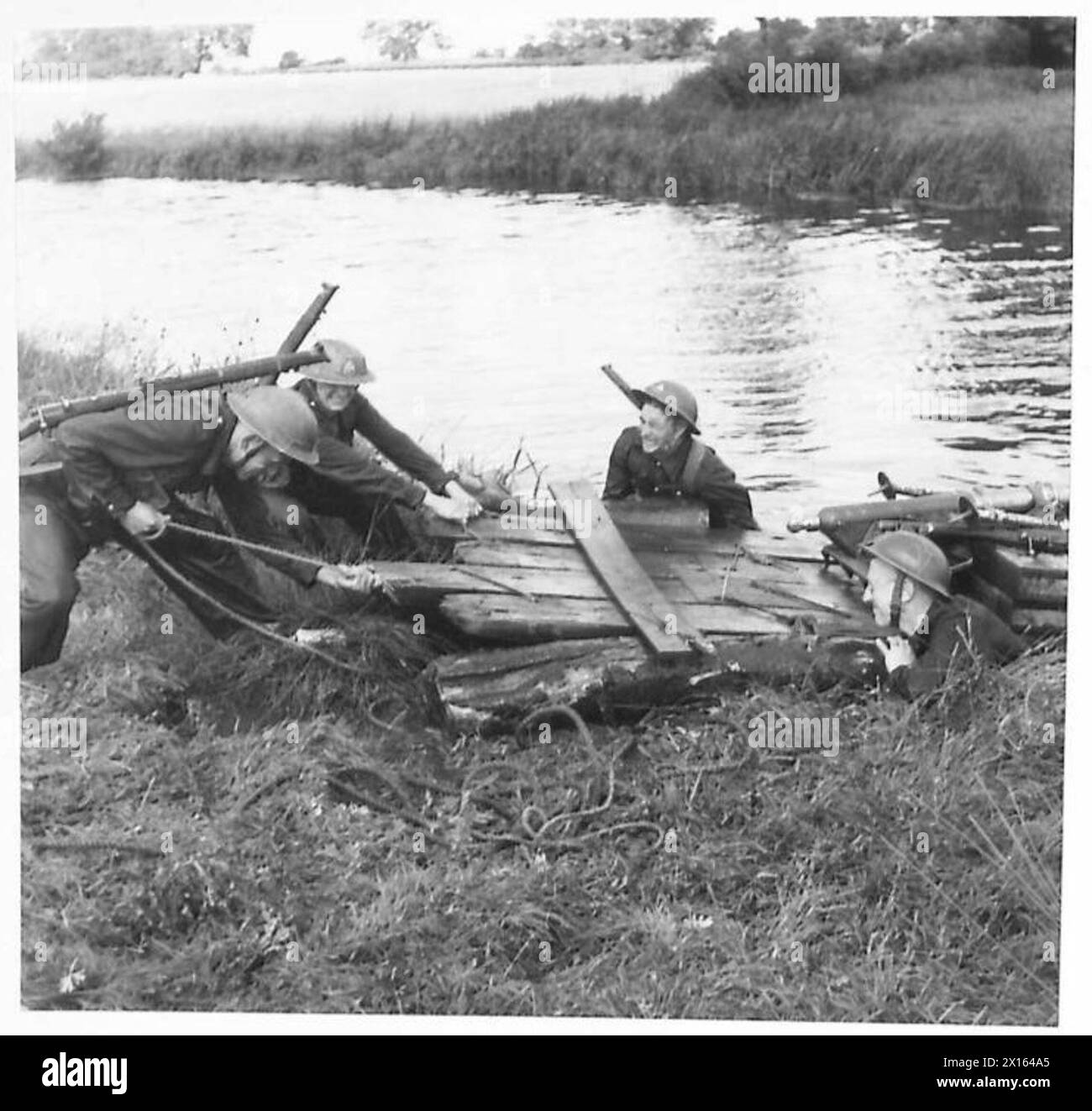 British Army personnel drag a raft ashore, demonstrating field ...