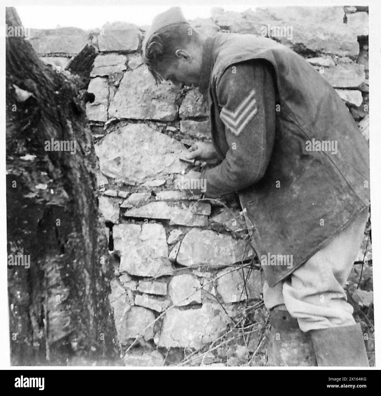 Sgt. S. Crozier of Northern Ireland lights a safety fuse for a ...