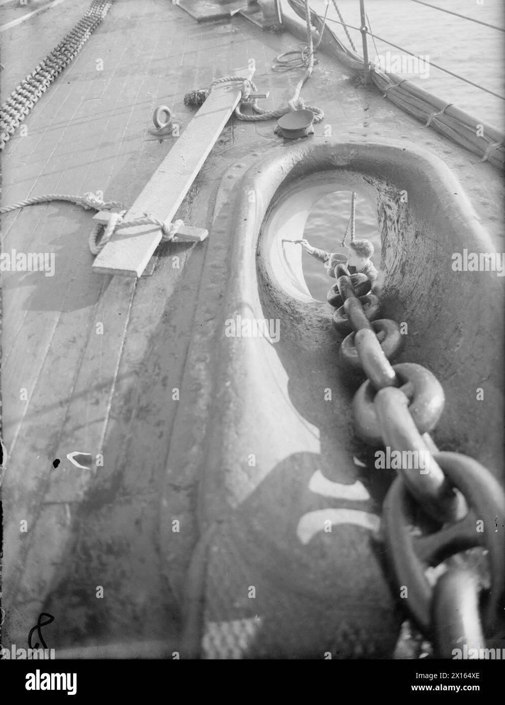 In October 1940, aboard the battleship HMS Rodney, crew members painted ...