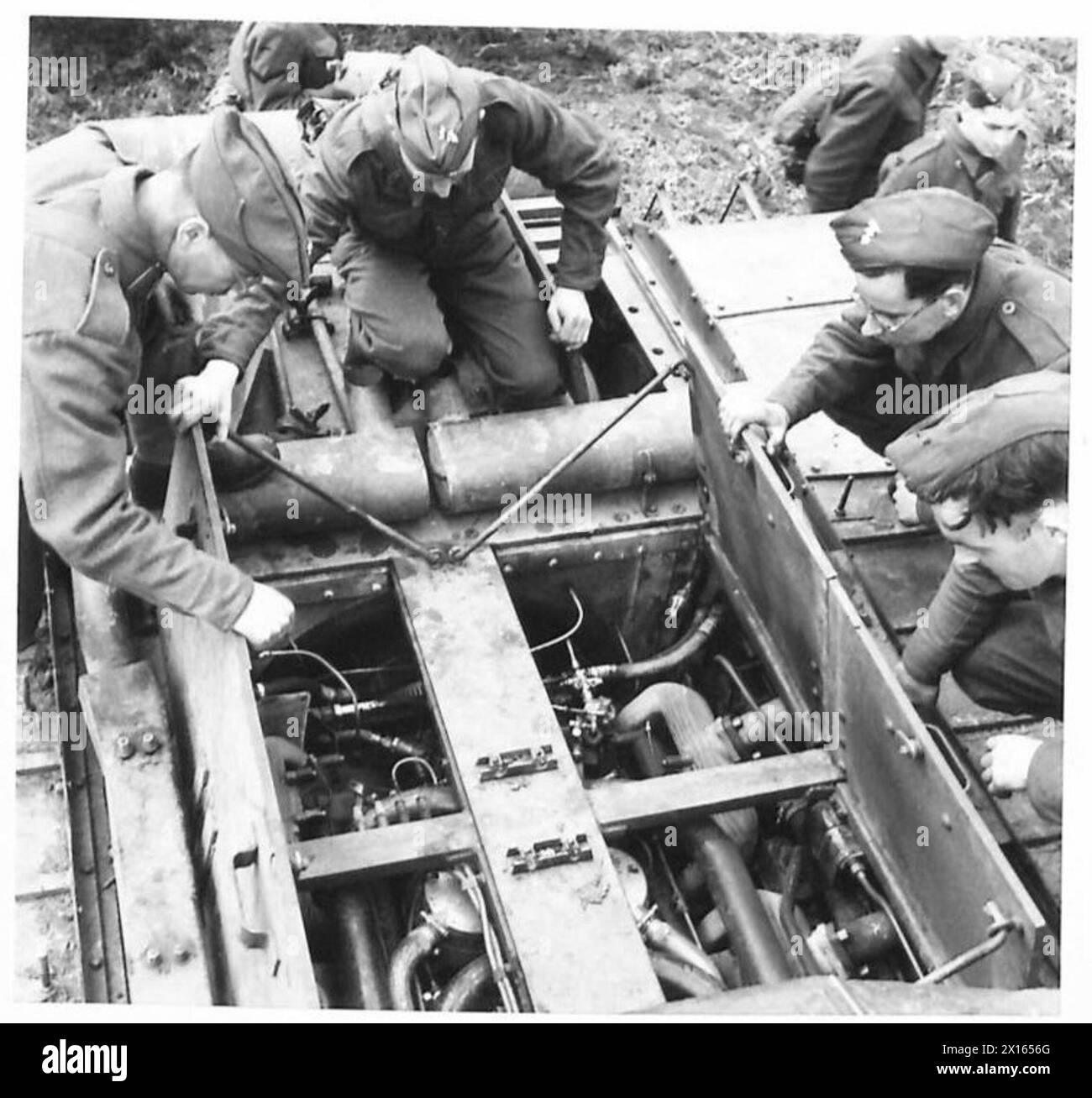ARMY TANK BRIGADE DEMONSTRATION - Troops examining the engine of a ...