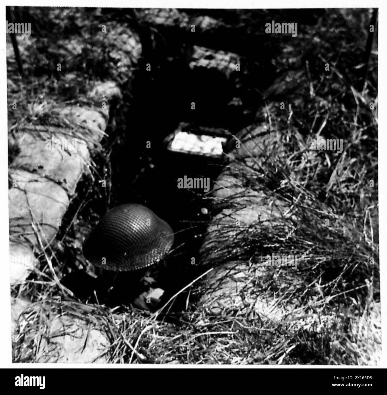 The No.21 wireless telegraphy set is concealed in a trench by personnel ...