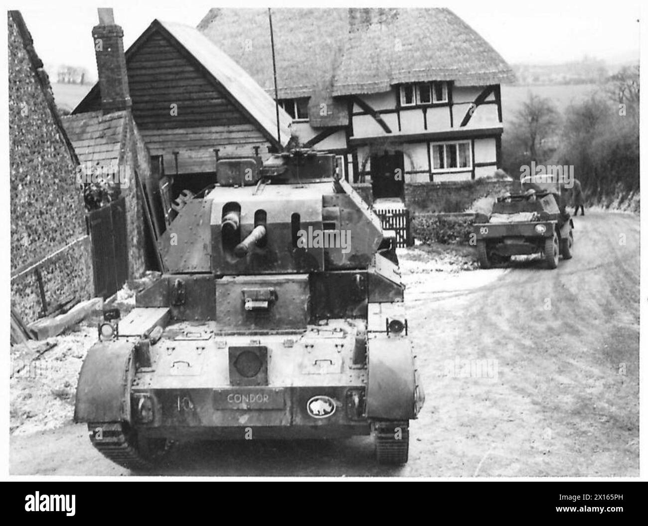 A TANK EXERCISE - A cruiser tank with scout car behind at a picturesque ...