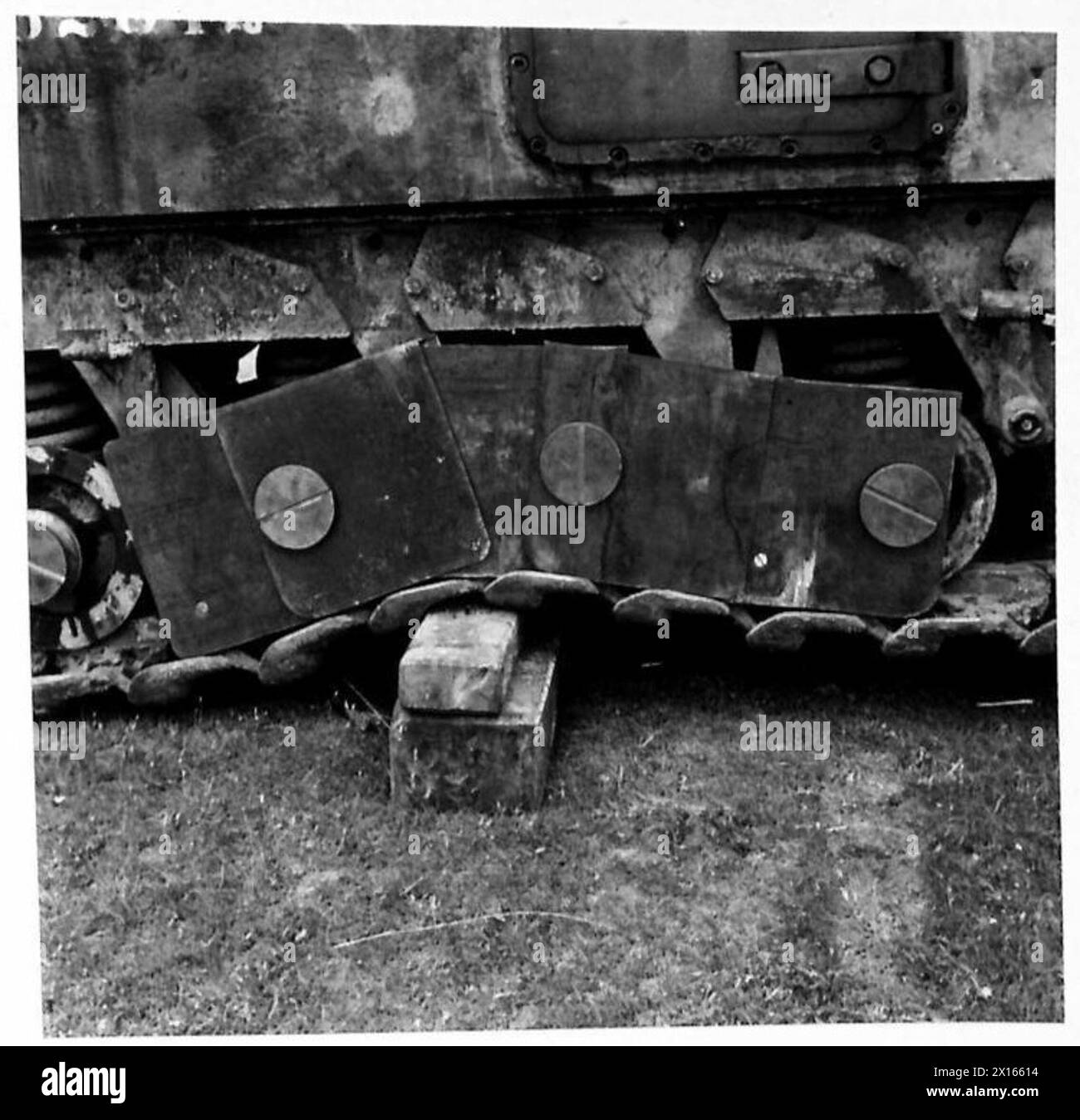 Plates on a tank recovery vehicle articulate as the tank passes over ...