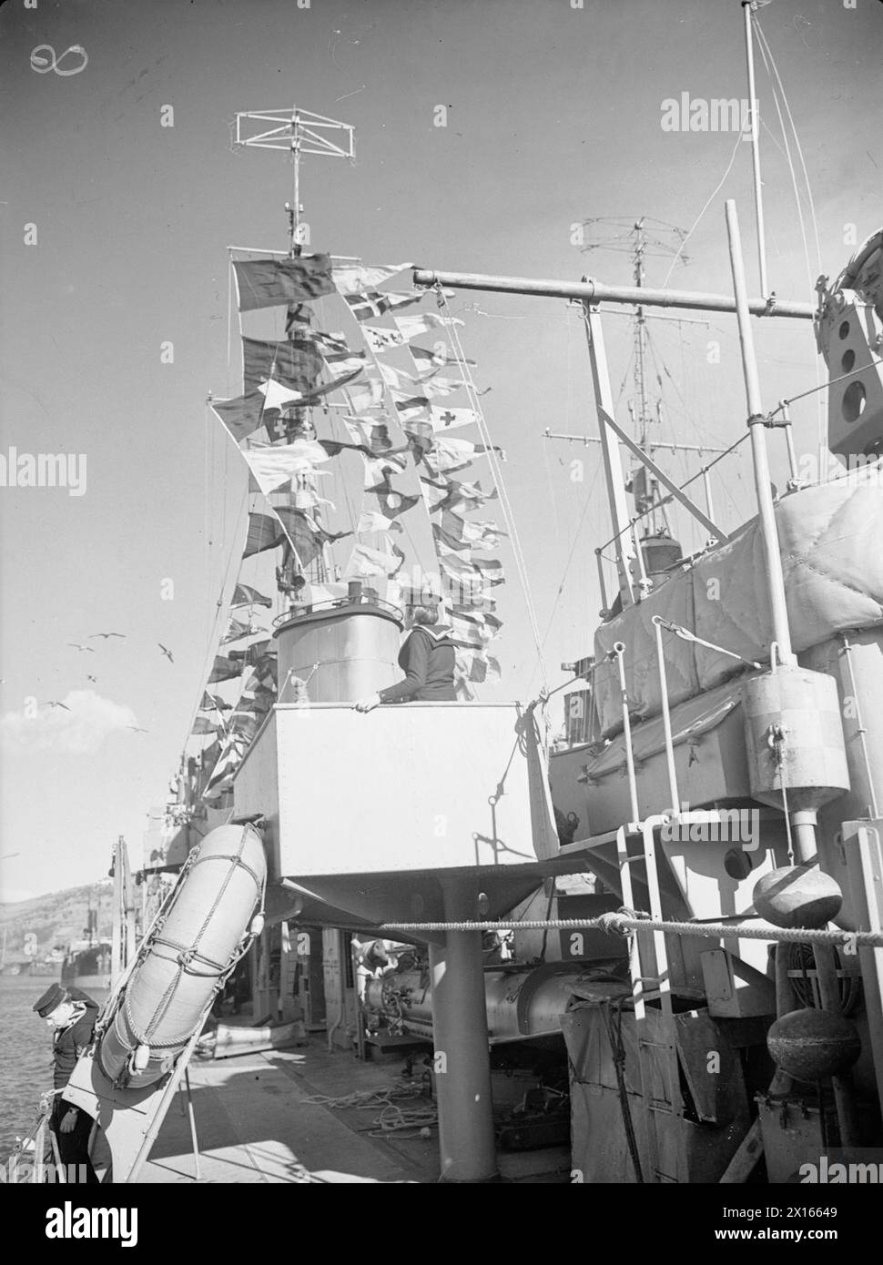 Onboard HMS Kipling of the Fifth Destroyer Flotilla, signal flags are ...