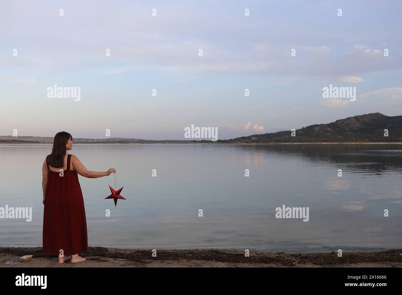 A female praying holding red star. femininity, , mindfulness, wellness ...