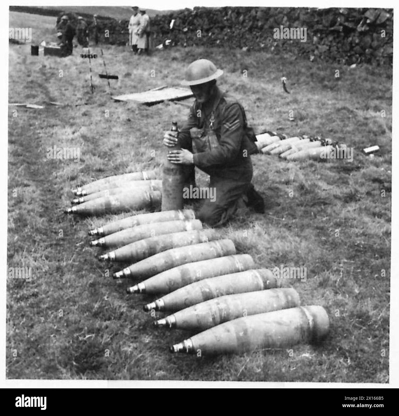 ARTILLERY ON A SCOTTISH MOOR - Screwing on fuse caps to the shells ...