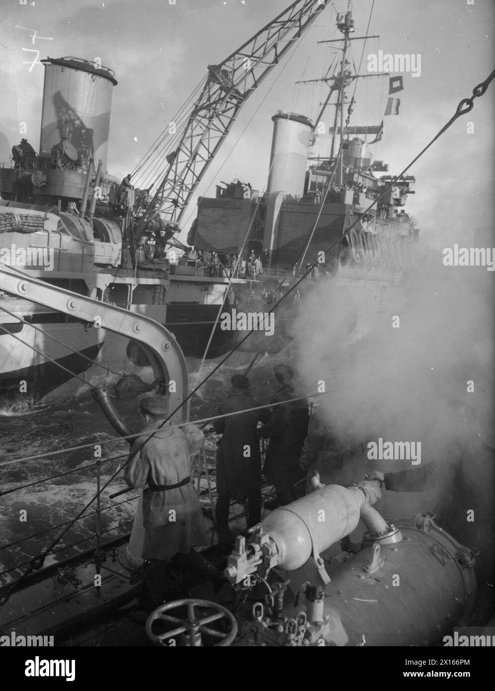 HMS Fury refuels from cruiser HMS Trinidad at sea in the North Atlantic ...