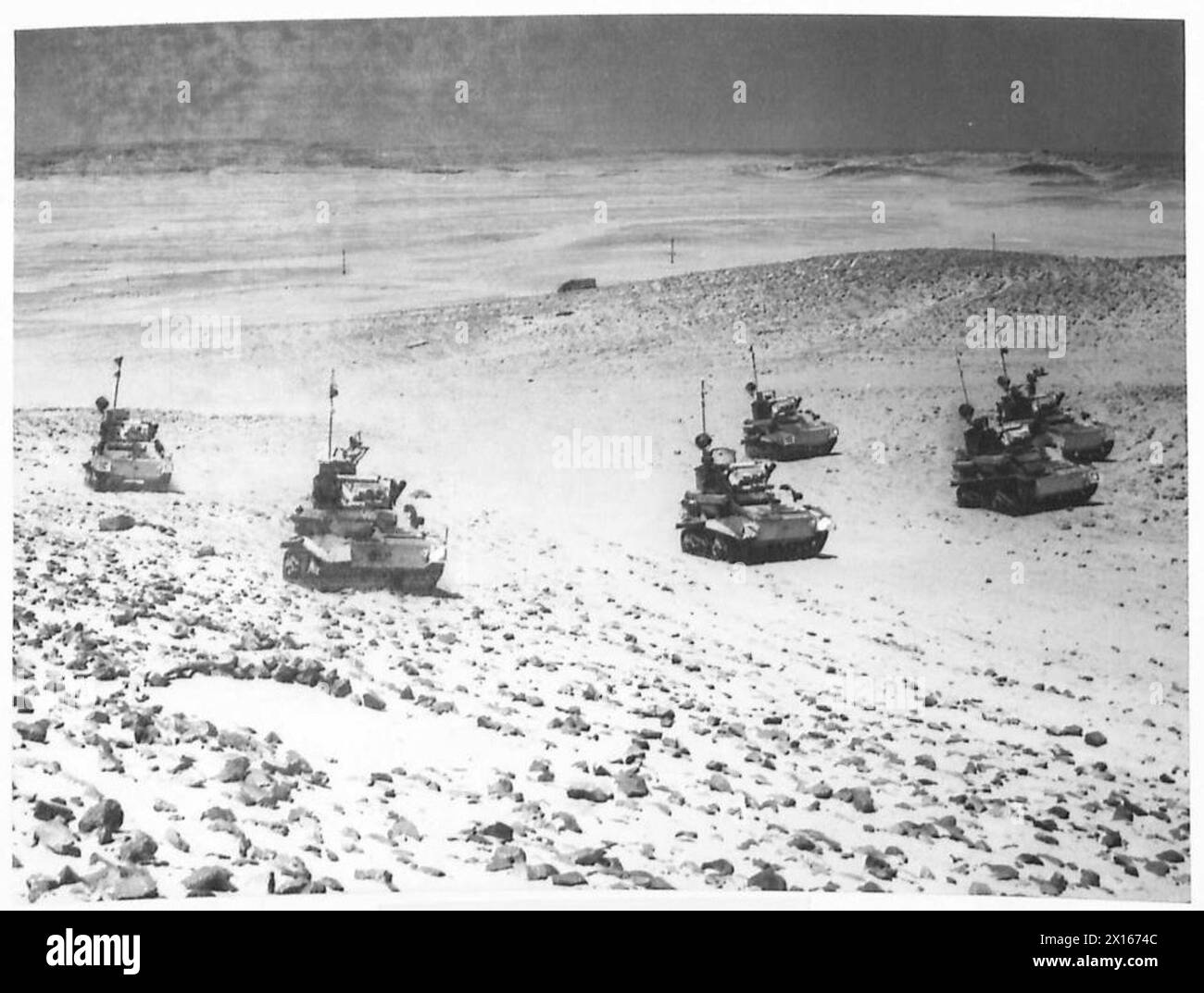 Tanks advance into combat during desert operations Stock Photo - Alamy