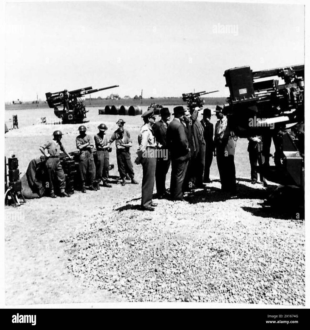 M.Ps SEE DEFENCE SCHEME - M.Ps inspecting one of the 3.7" guns at a ...