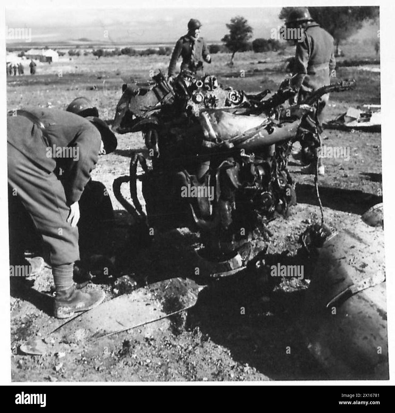 French Army troops examine the wreckage of a German aircraft, likely a ...