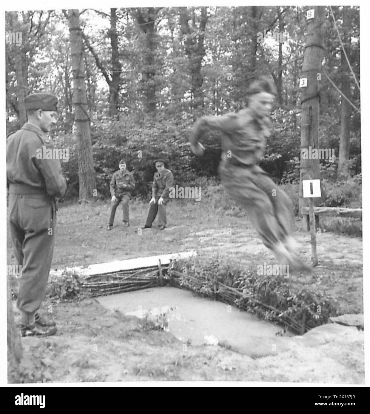 Candidates take the water jump obstacle No.1 as part of the selection ...