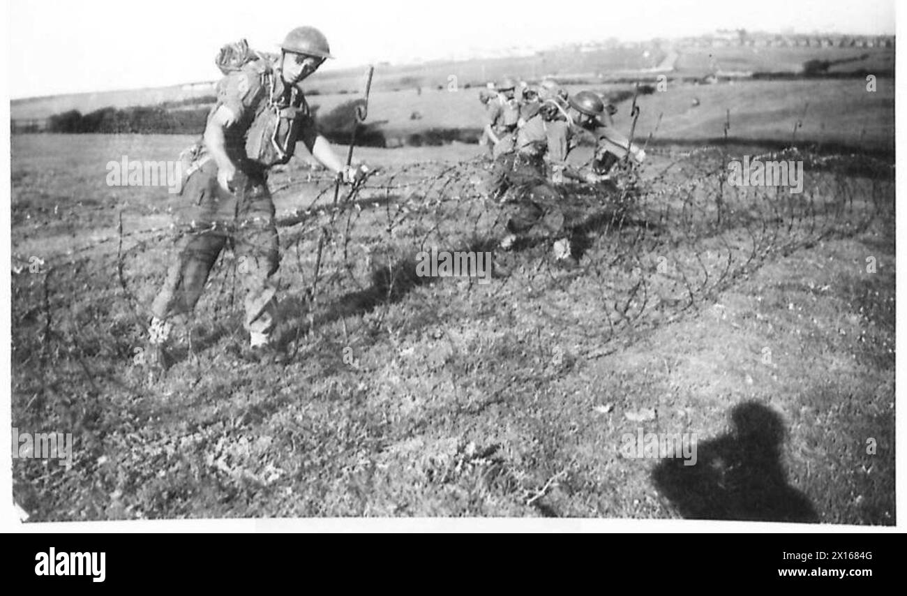TRAINING IN THE NORTHERN COMMAND - Rolls of barbed wire being fixed ...