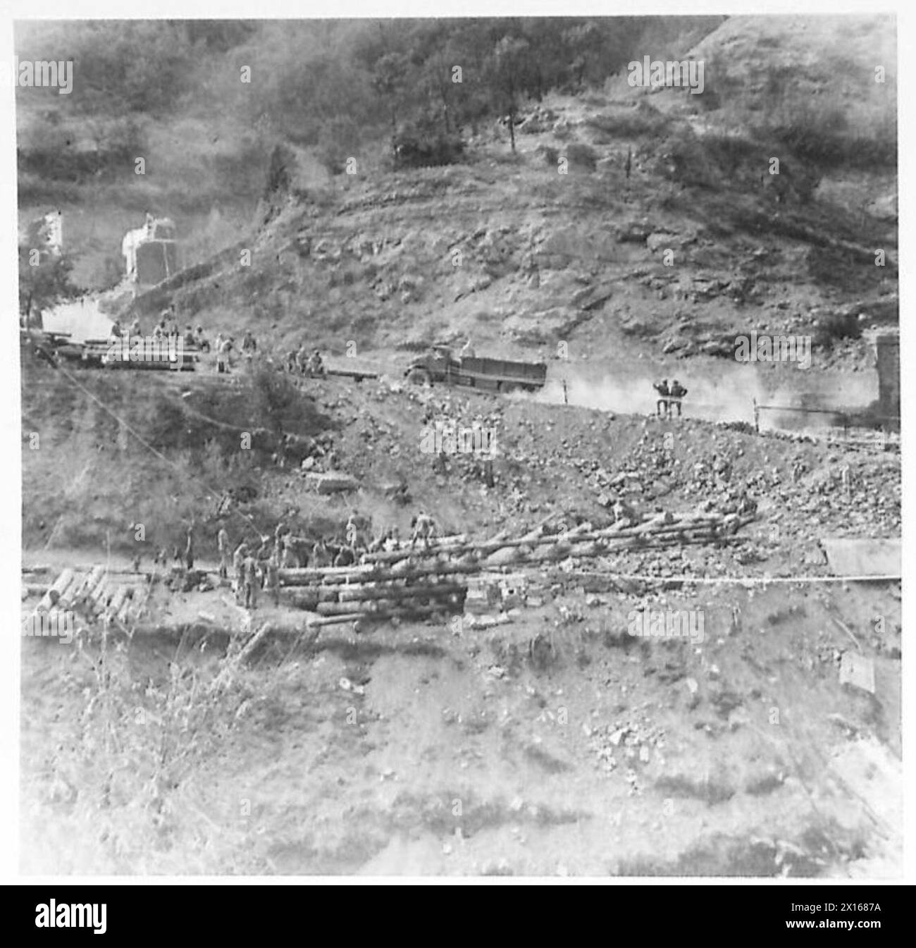 Royal Engineers construct a base for a Bailey bridge using cross ...