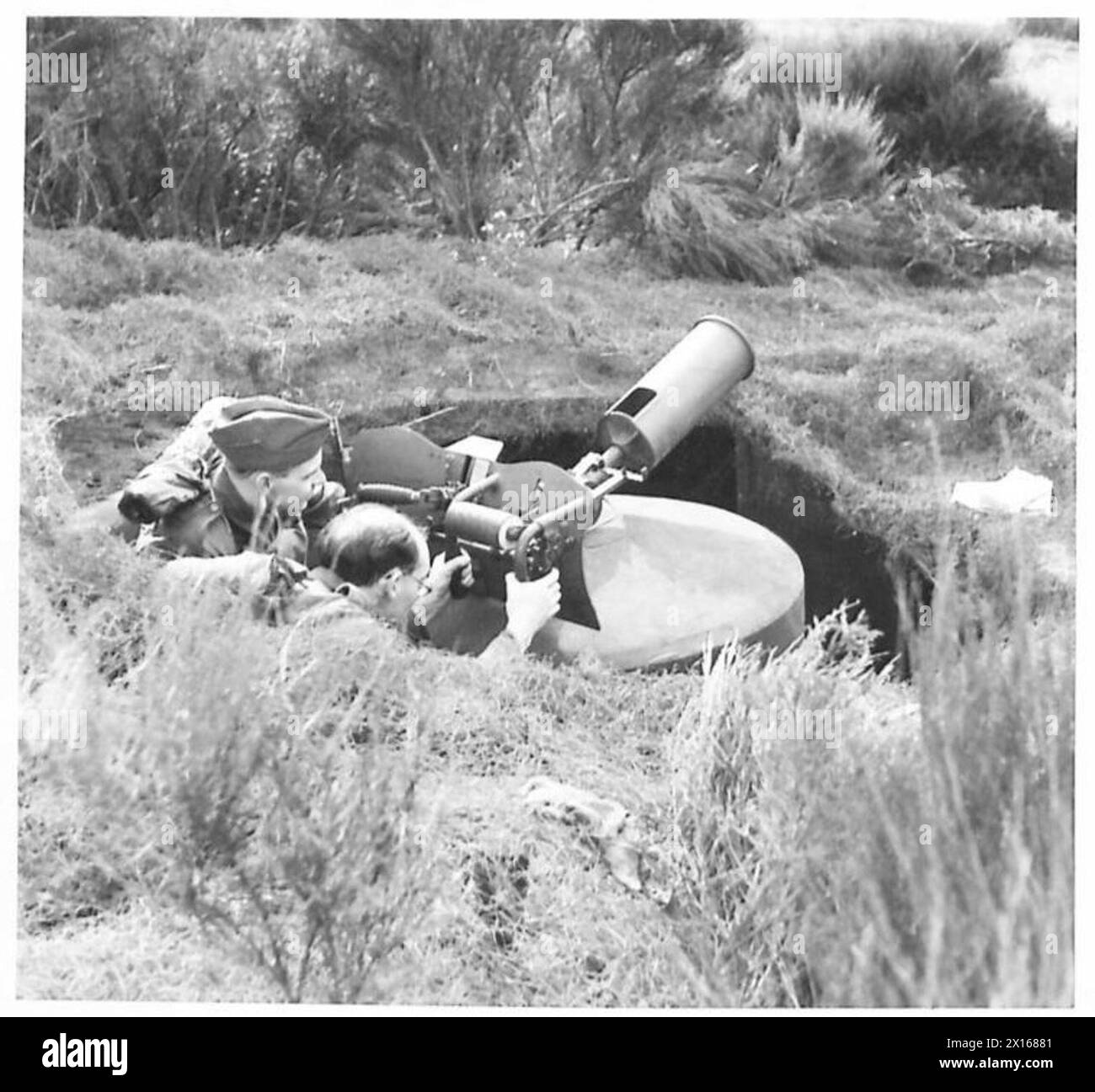 Home Guard personnel operate a spigot mortar to provide cover for a ...