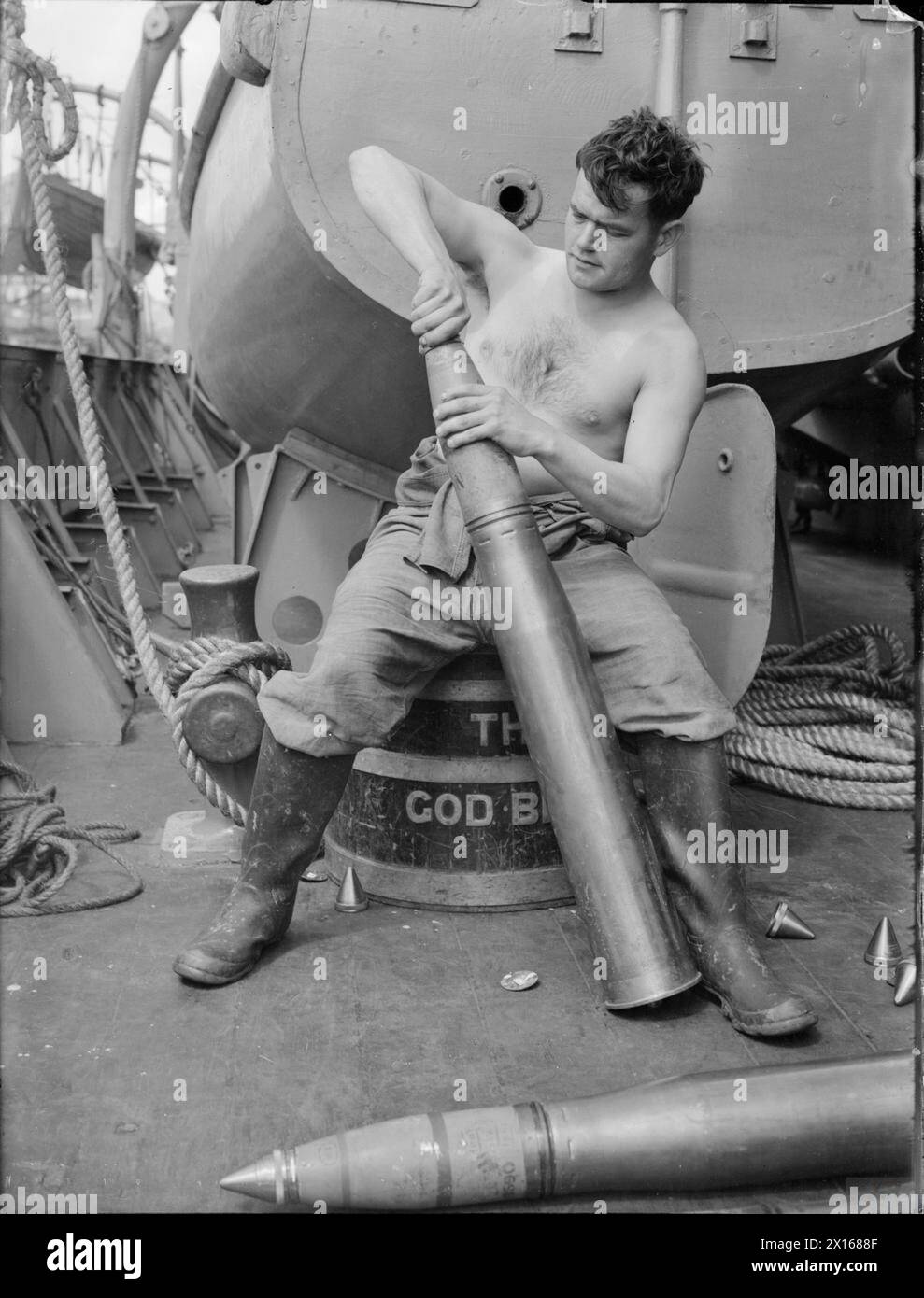An Able Seaman fuses a 4-inch shell aboard an anti-aircraft ship in ...