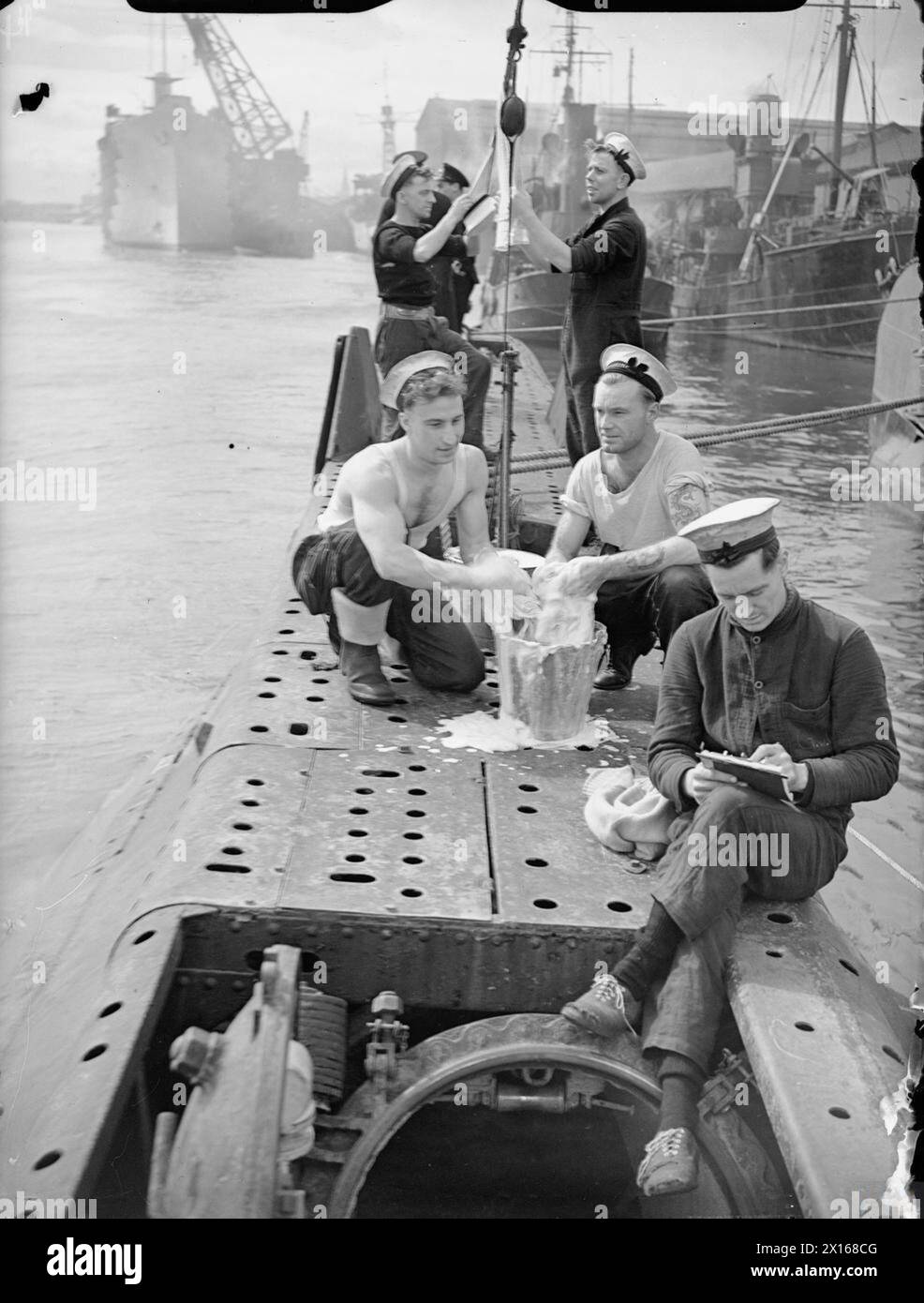 Sailors aboard HMS Sibyl perform dhobeying (laundry) and write letters ...