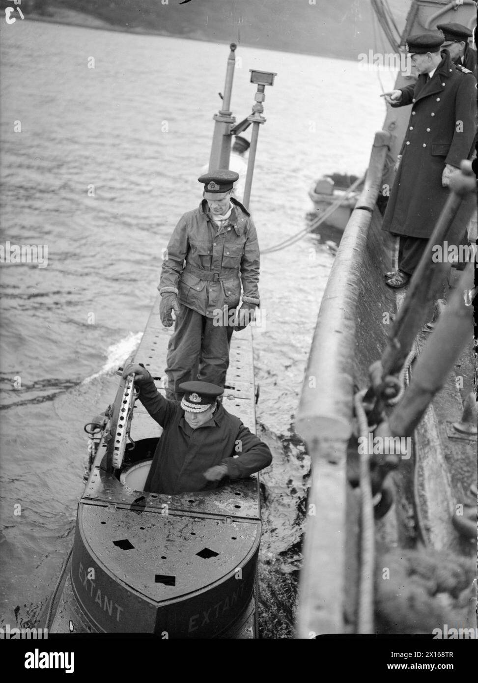 Rear Admiral C. B. Barry, Flag Officer Submarines, enters the conning ...