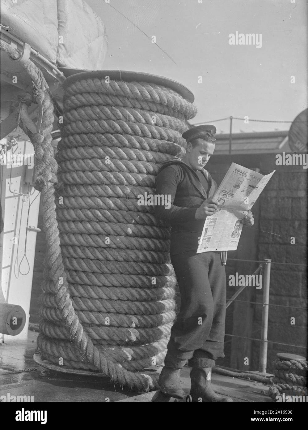 Onboard HMS Kipling in 1941, a large bobbin of thick hawser rope is ...