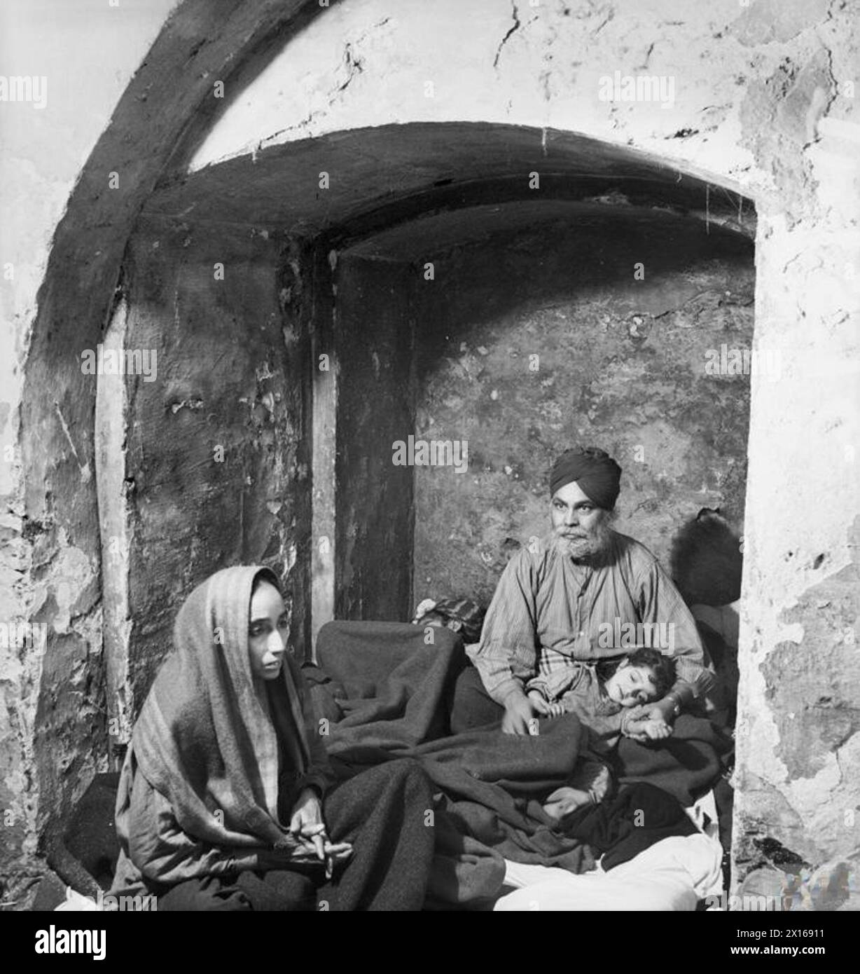 A Sikh family takes shelter in an alcove of the crypt at Christ Church ...