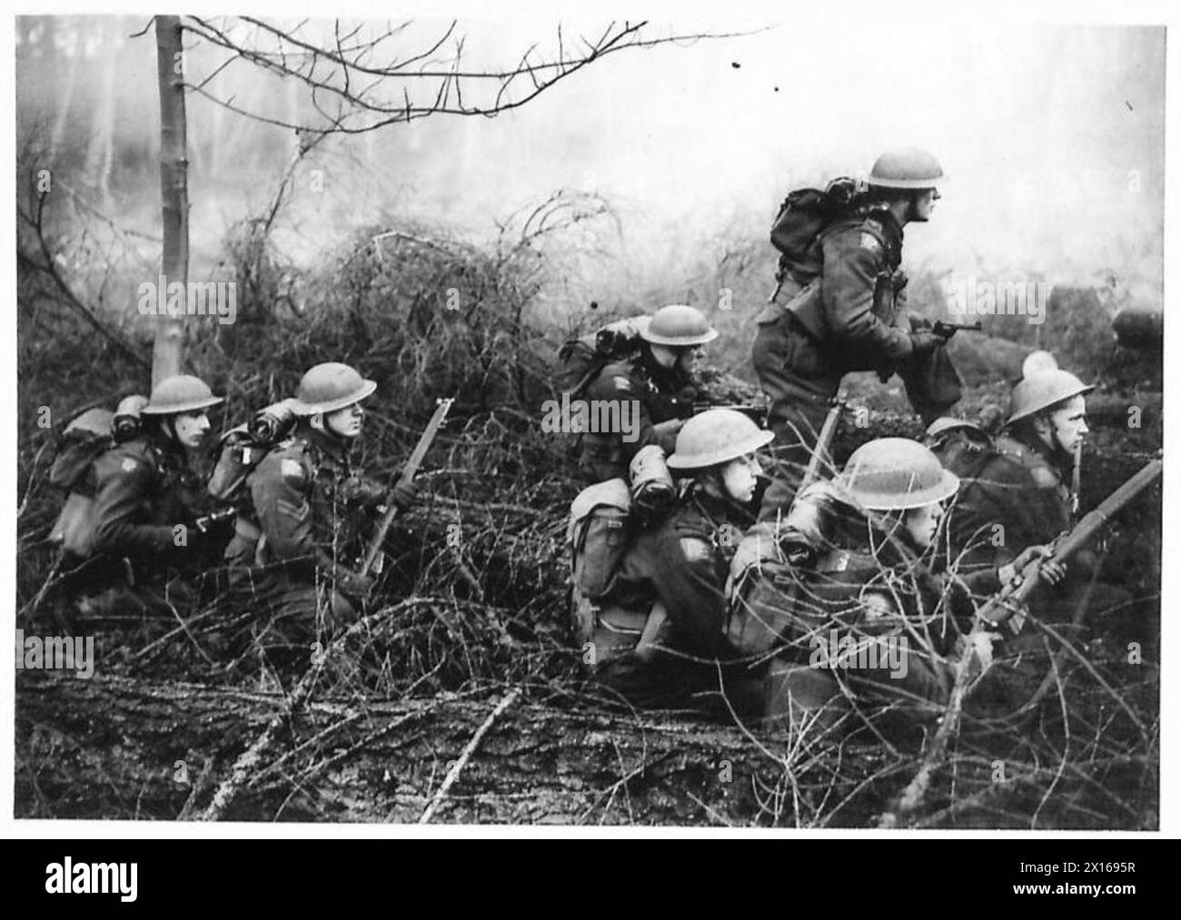 Troops disembarking from coaches and engaging in field manoeuvres as ...