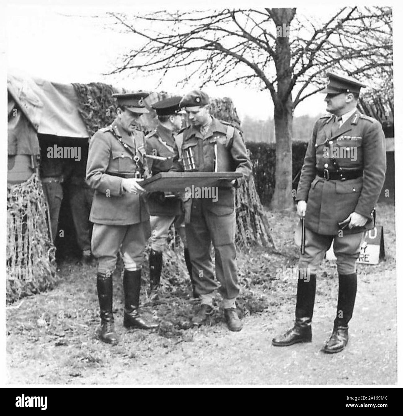 General Sir Bernard Paget, Commander-in-Chief Home Forces, studies a ...