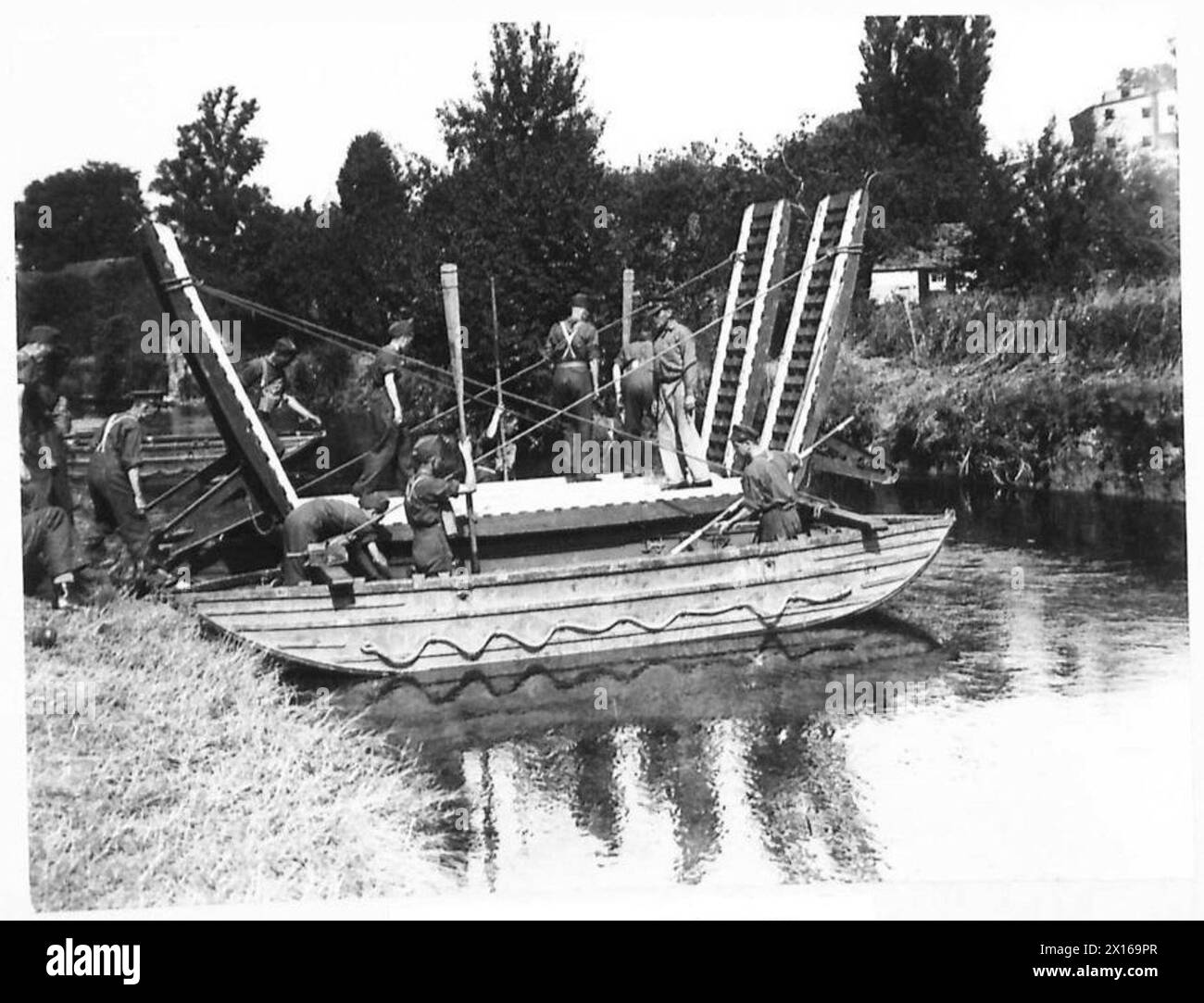 A section of a pontoon bridge is positioned during Royal Engineers ...