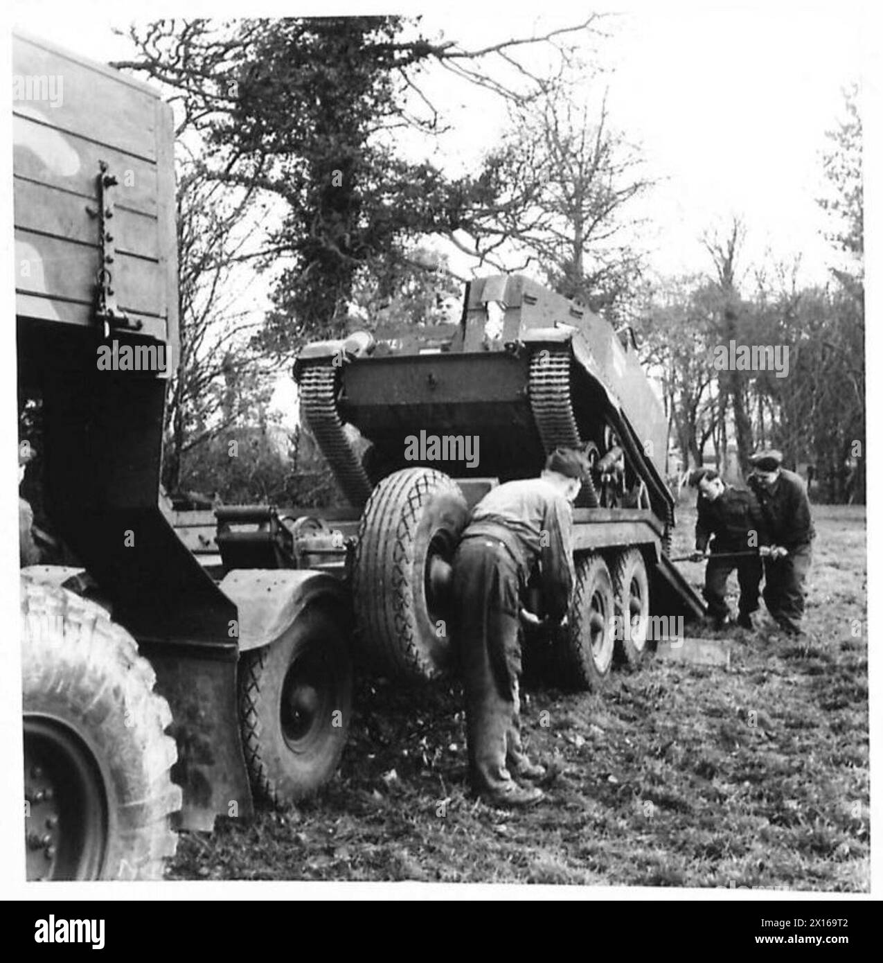 Royal Electrical and Mechanical Engineers winch a carrier onto a ...