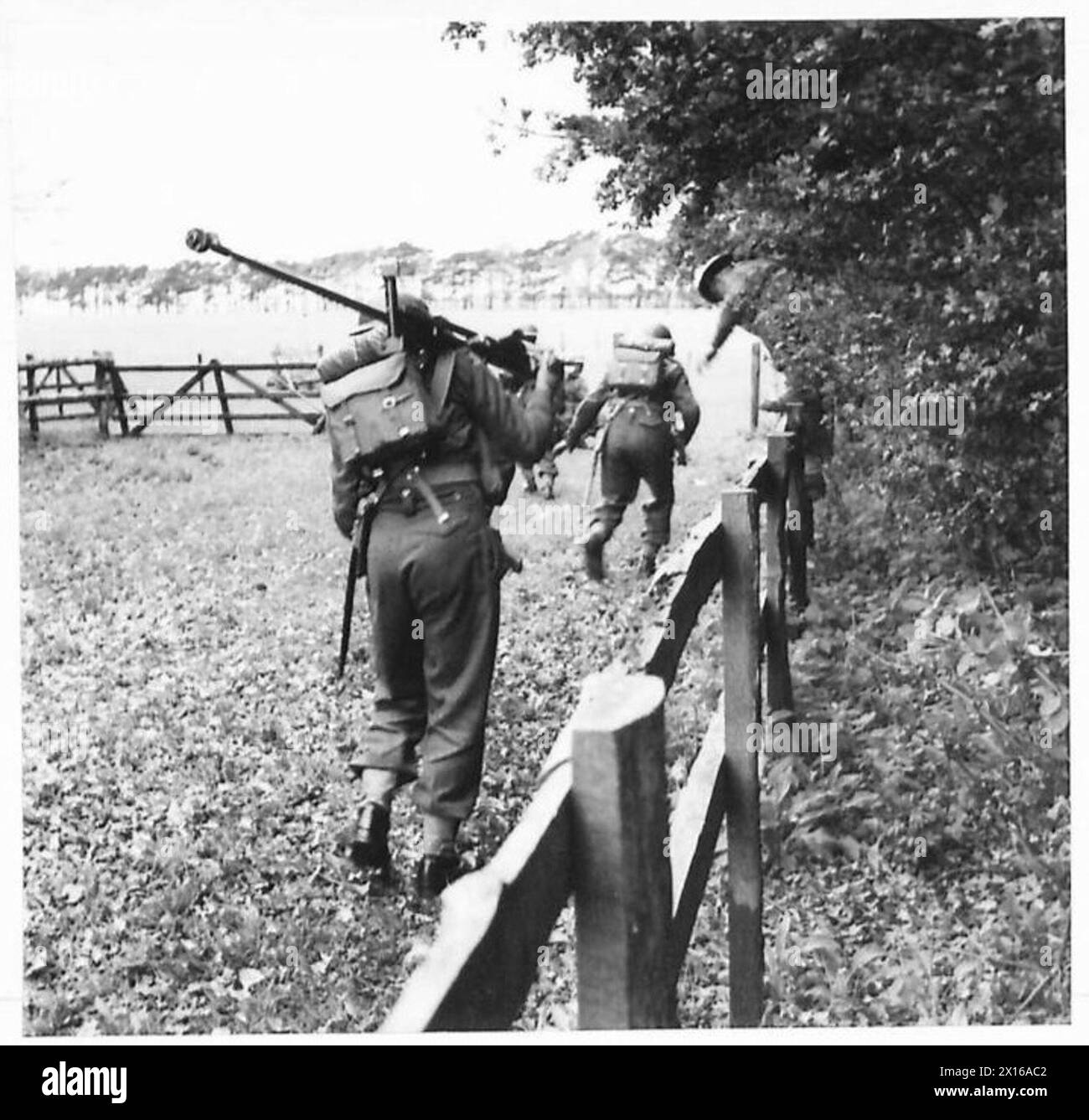 A WOODLAND EXERCISE - A patrol leaving cover. The nearest man is ...