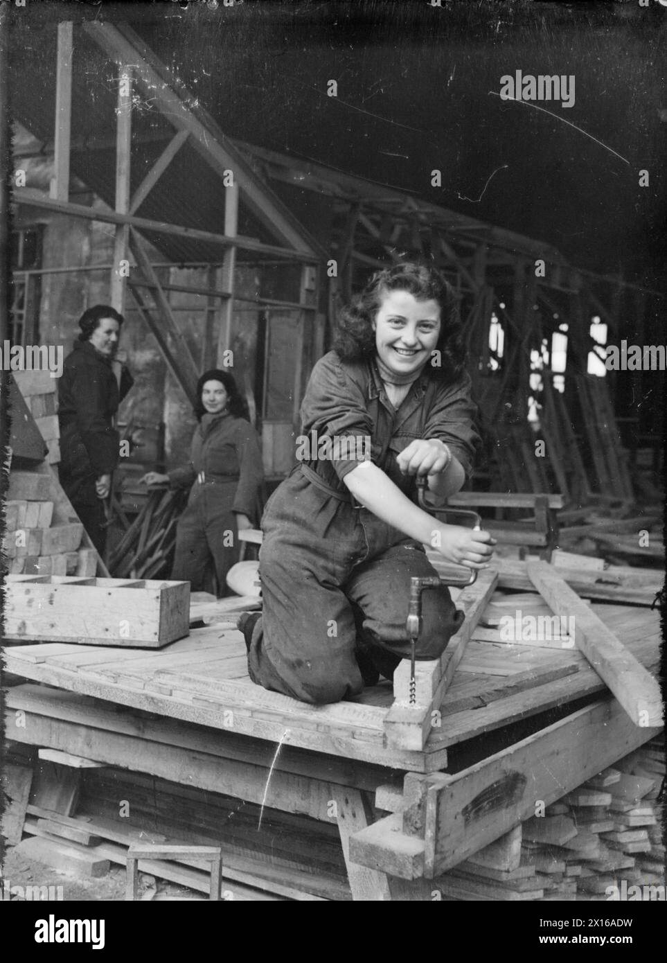 16-year-old Stella Day drills a hole in a wooden beam during hut ...