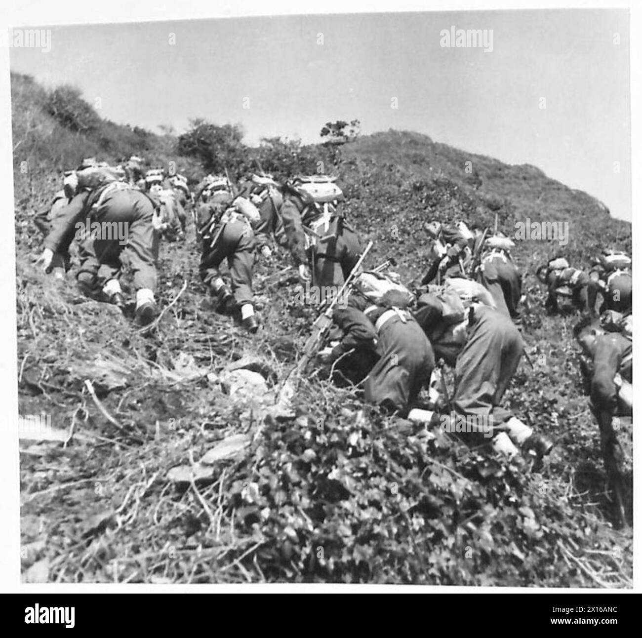 LIVING ON THE COUNTRY - Men racing up a steel hillside carrying full ...