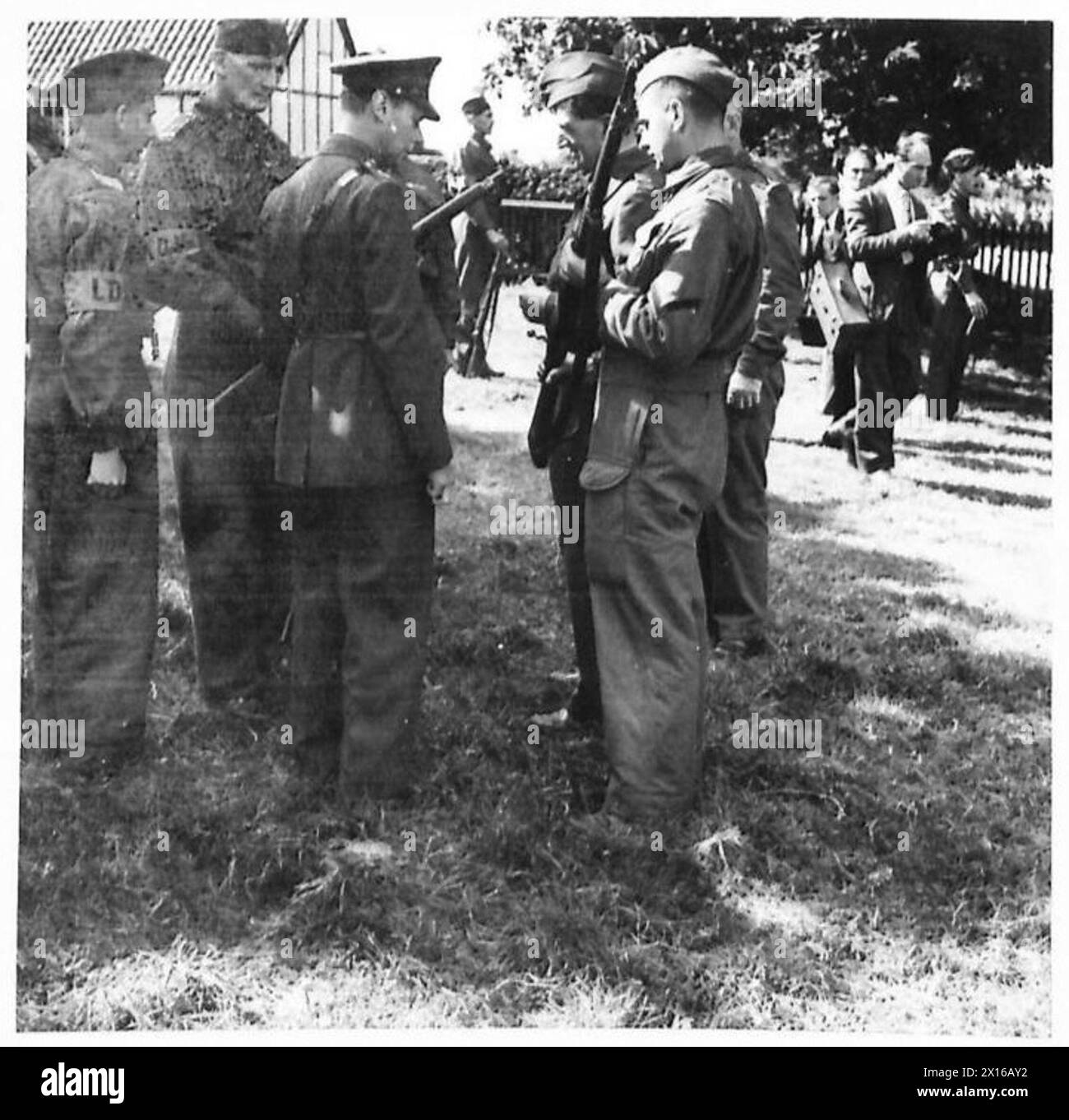 HIS MAJESTY THE KING INSPECTS HOME GUARDS - The King making enquiries ...