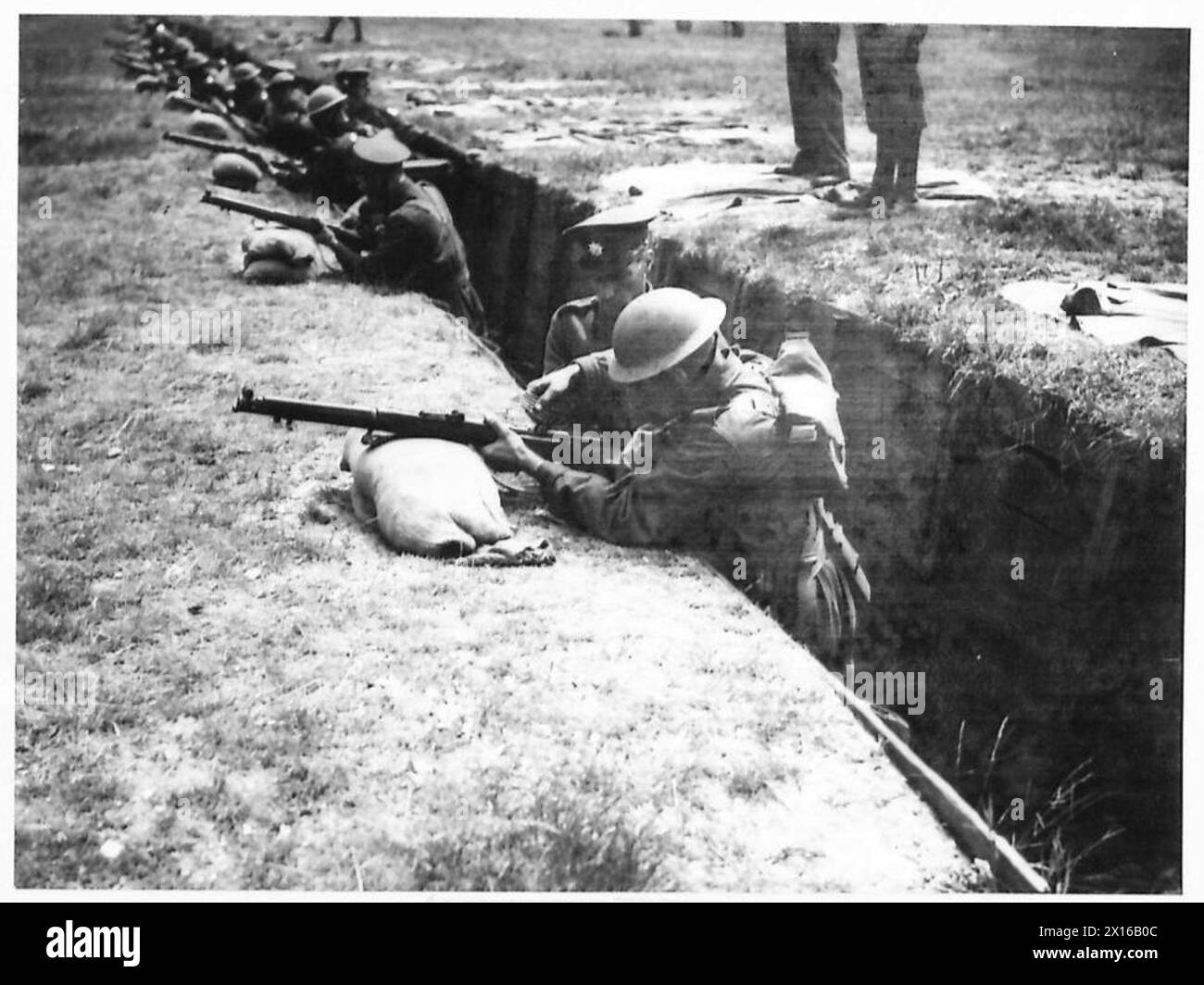 Coldstream Guards practice firing rifles while wearing respirators ...