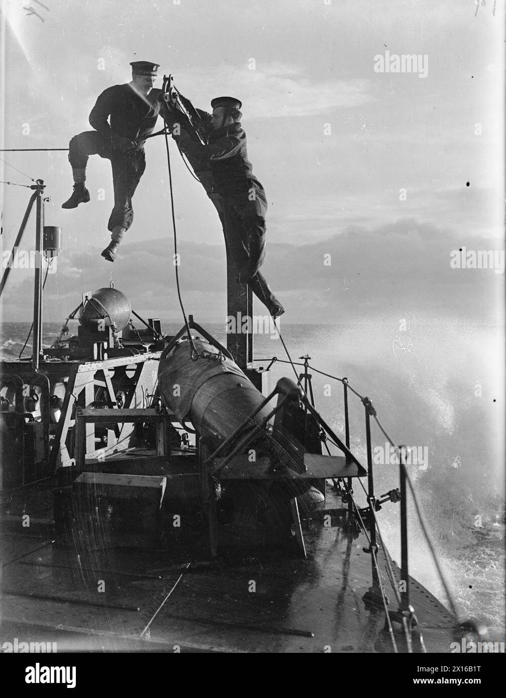 Polish Navy sailors perform a running repair at sea using the paravane ...