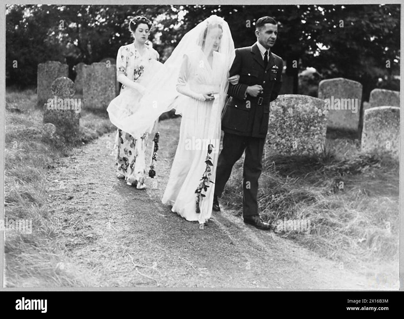 The Commanding Officer of the RAF station accompanies the bride during ...