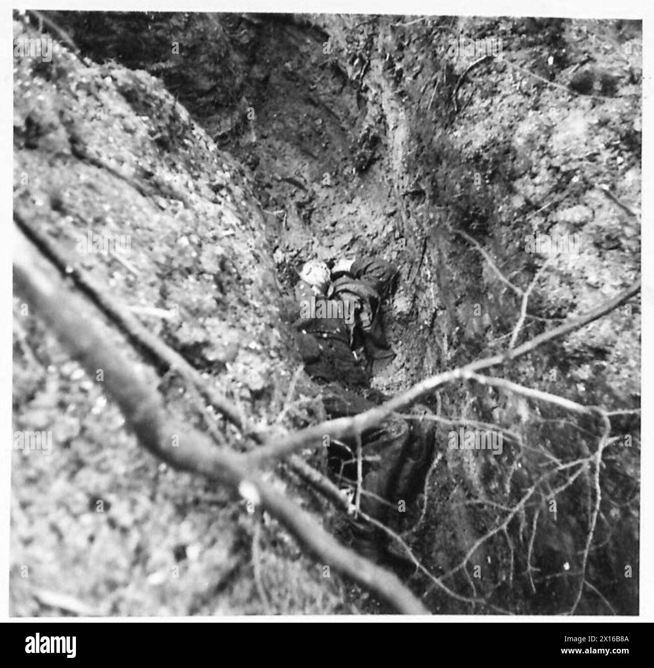 BRITISH TROOPS ENTER GERMANY - One of the German dead found in a slit ...