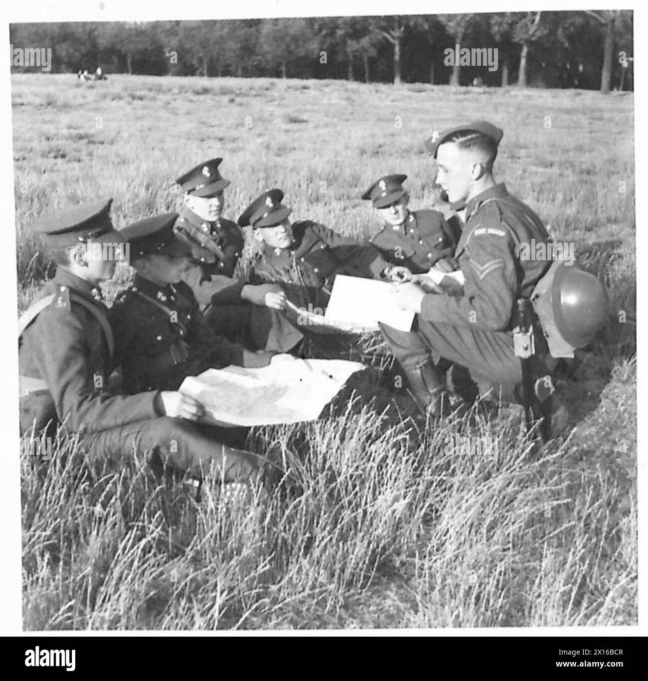 A group of cadets over 17 receives instruction in map reading from a ...