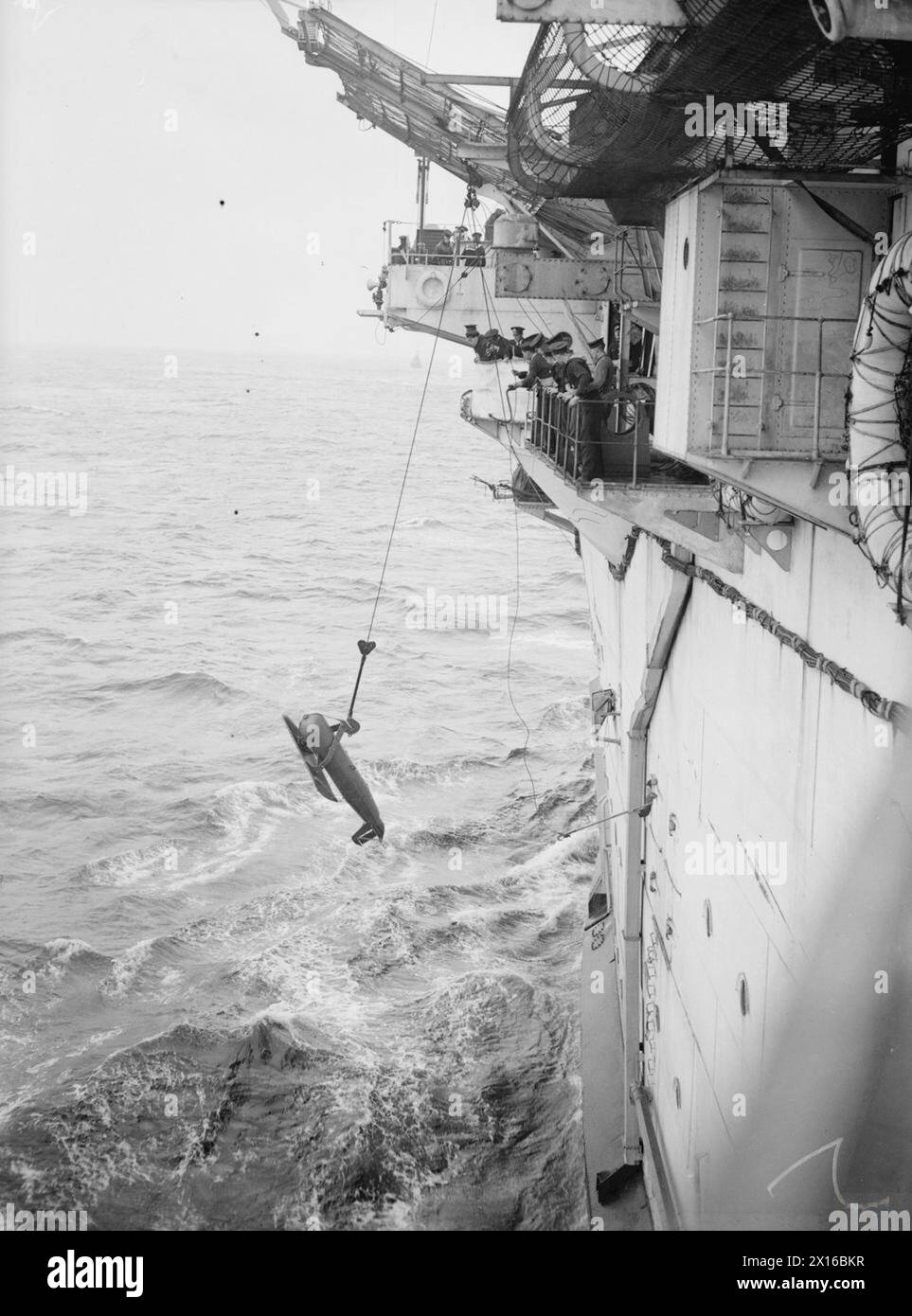 A paravane for clearing mines is deployed on board the aircraft carrier ...