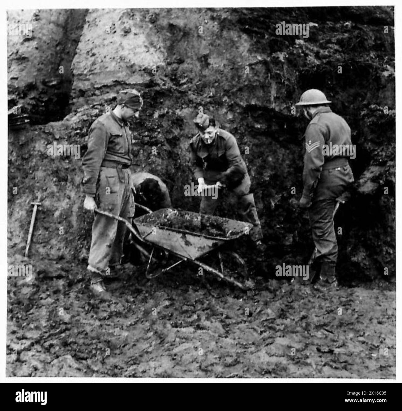 Workers excavate a sump while constructing a new road through the ...