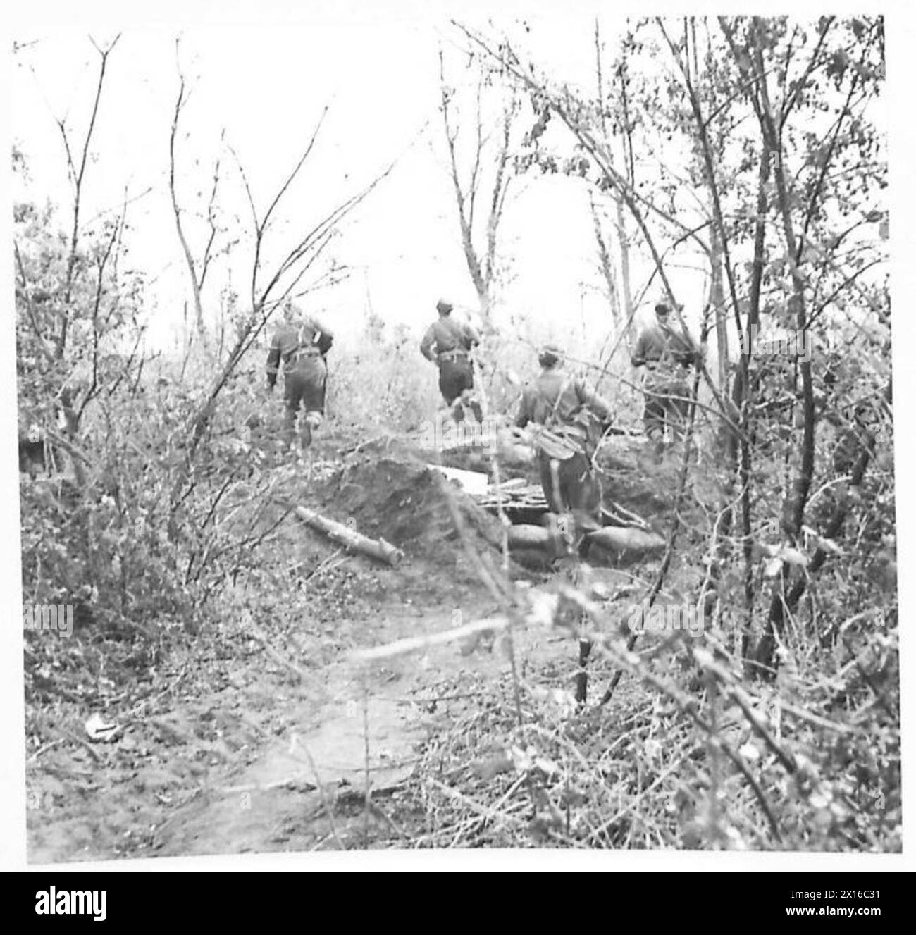 A British Army patrol advances to clear enemy survivors following a ...