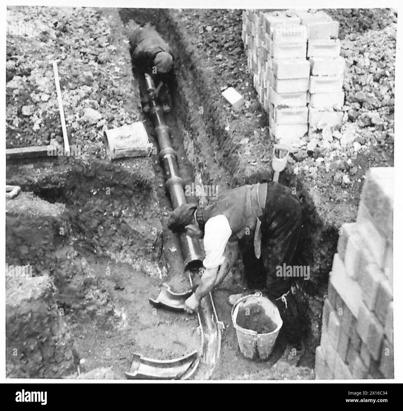 ANOTHER NEW ARMY CAMP - At work on drain connections for sewer British ...
